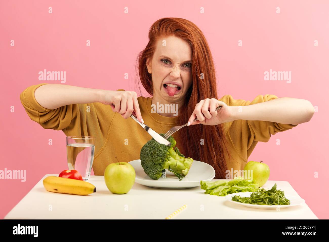 Red-haired woman in bad temper keeping strict vegetarian diet being ...