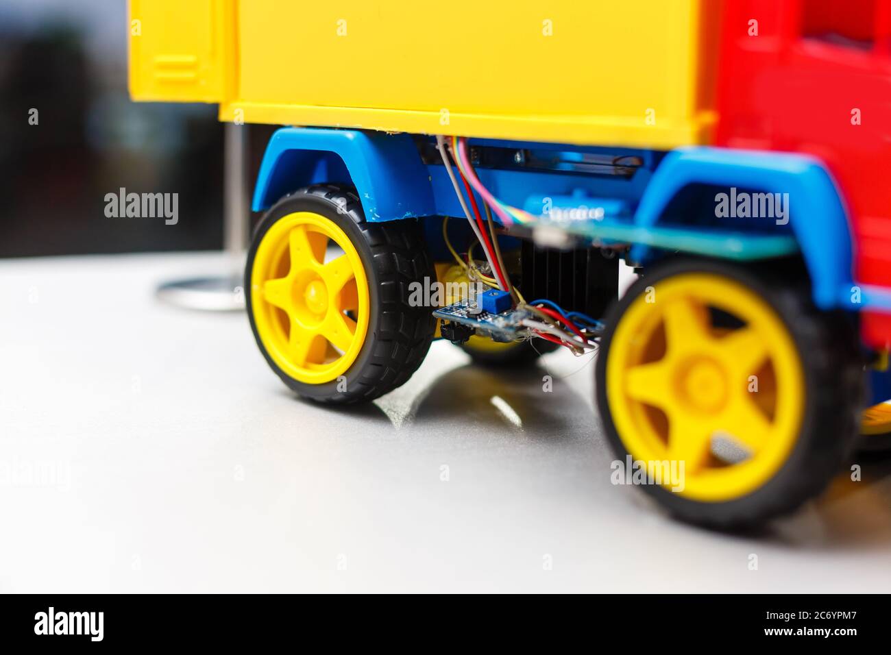 A blue yellow and red toy car Stock Photo - Alamy