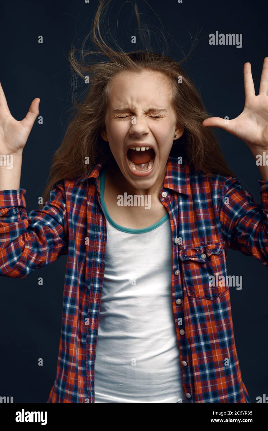 Little girl shouting in studio, developing hair Stock Photo - Alamy