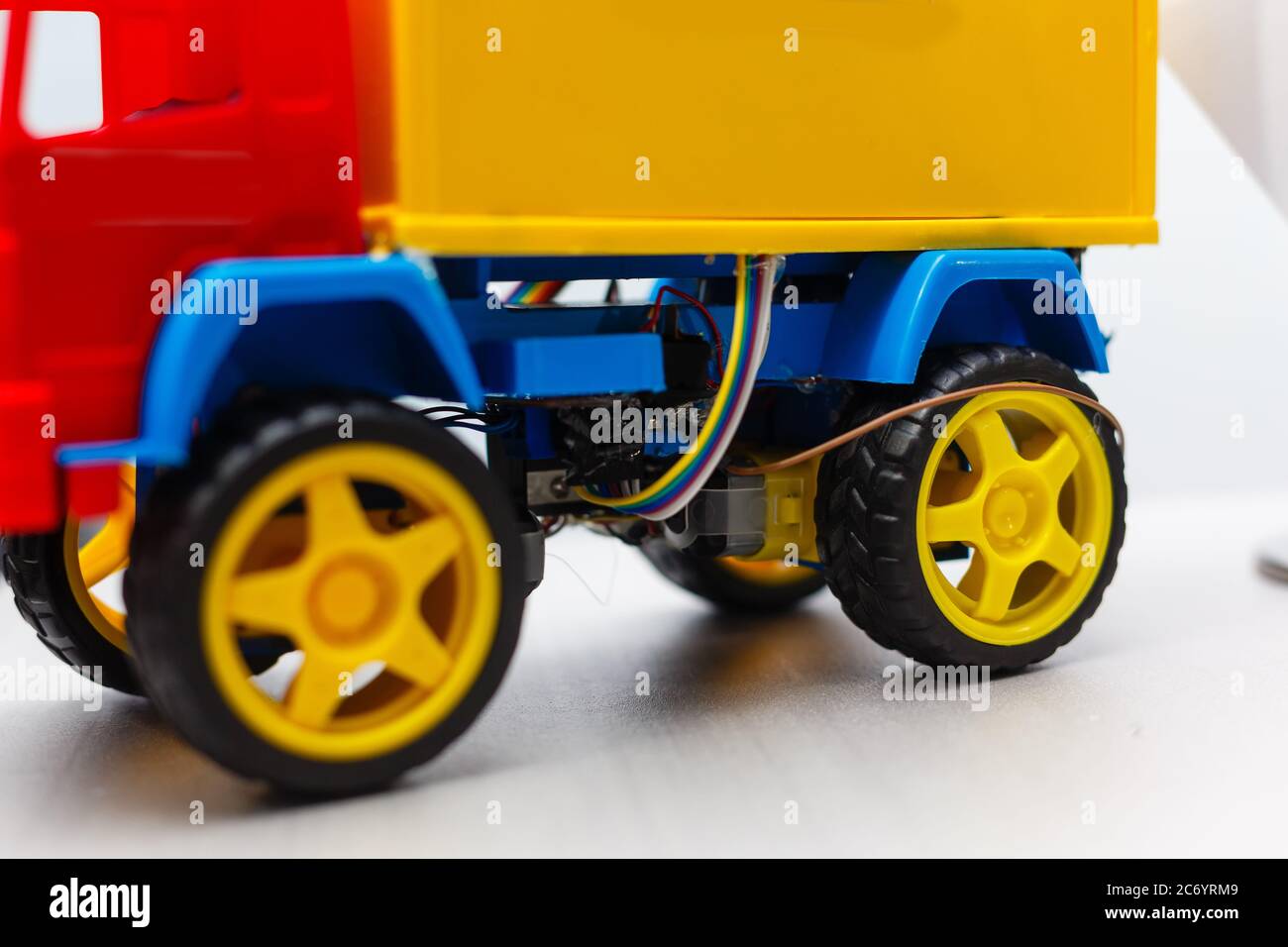 A blue yellow and red toy car Stock Photo - Alamy