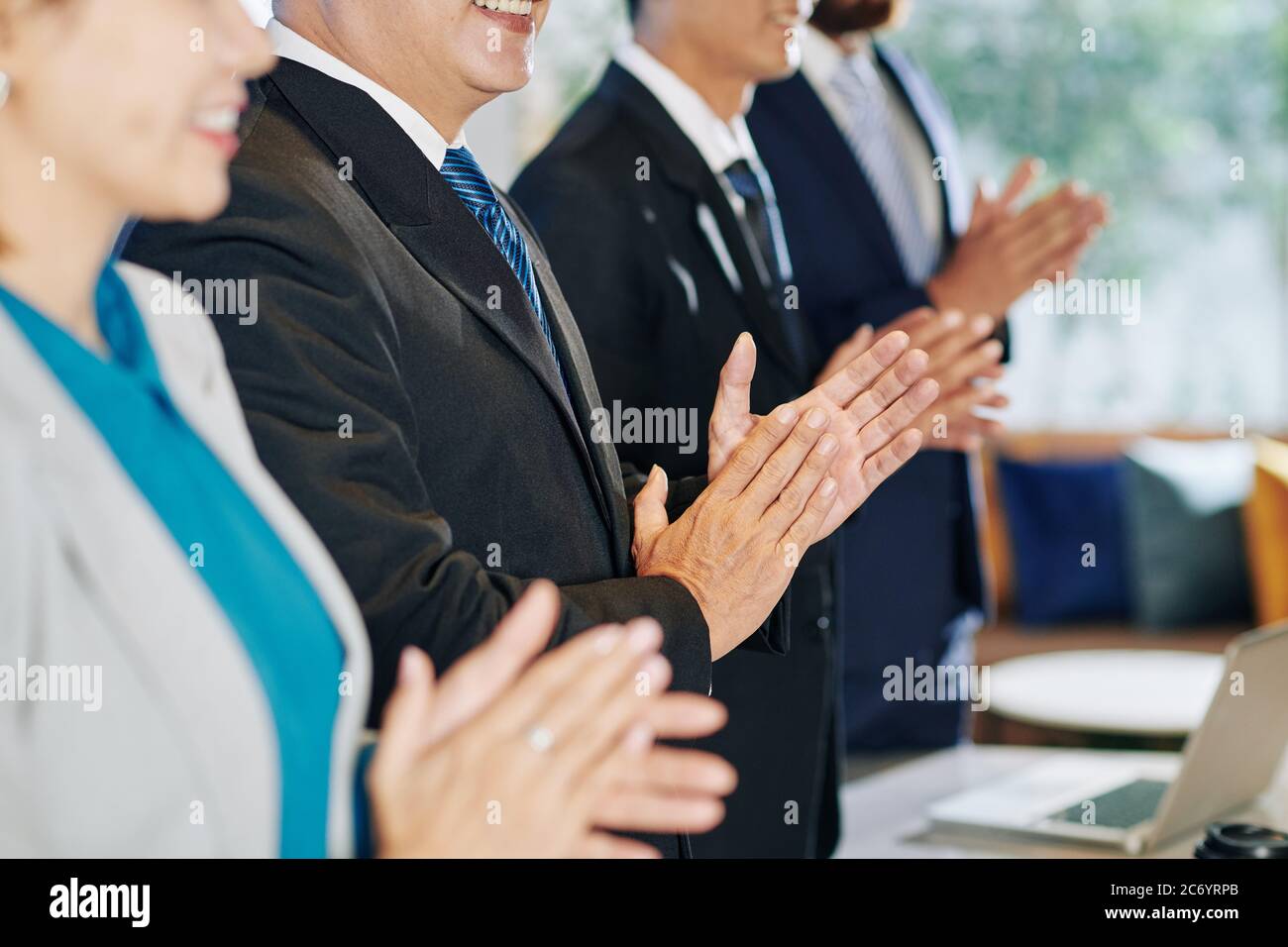 Business people standing at clapping to coworker after his inspiring ...