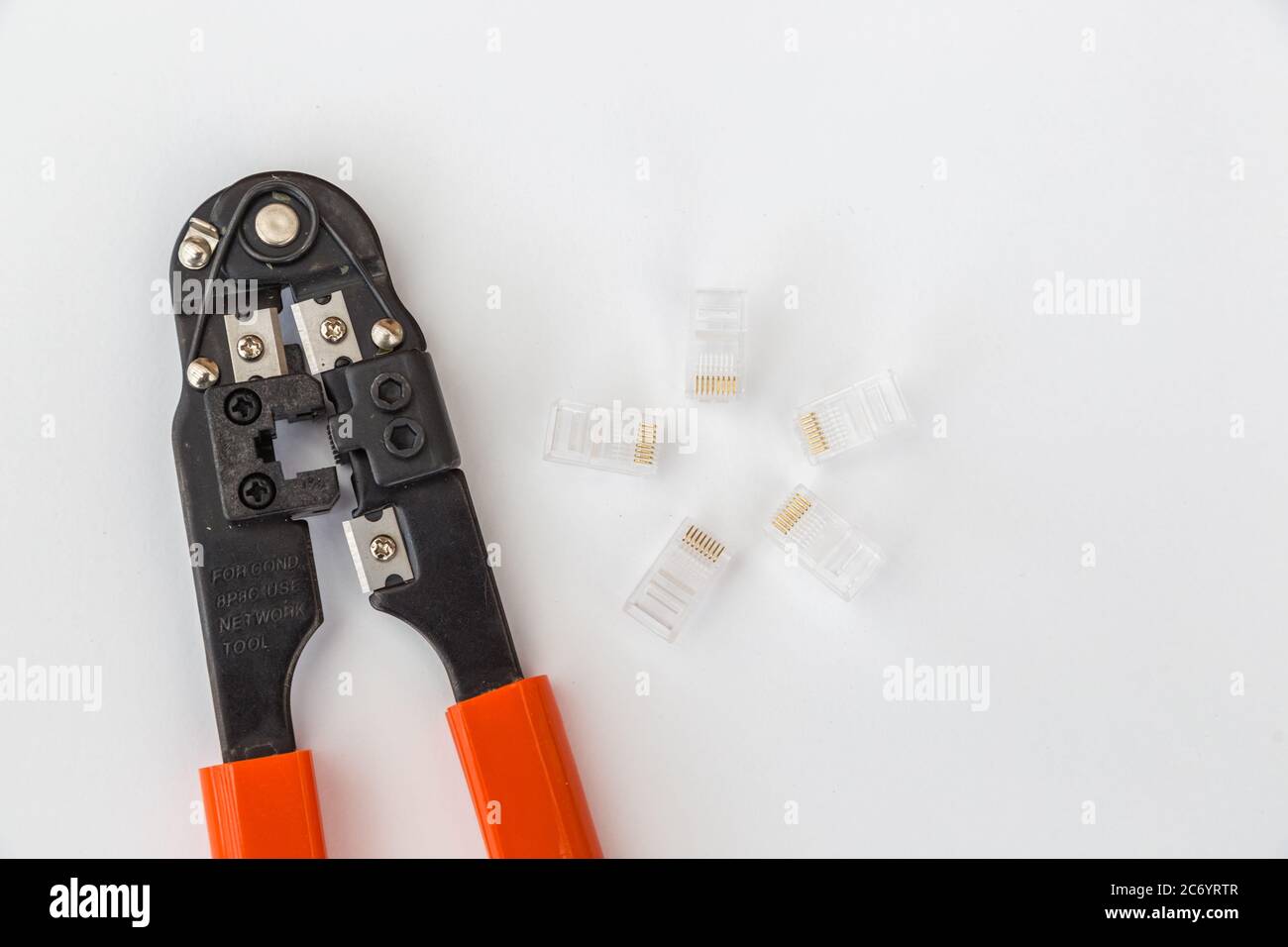 Crimping RJ45 LAN cable on a white background Stock Photo - Alamy