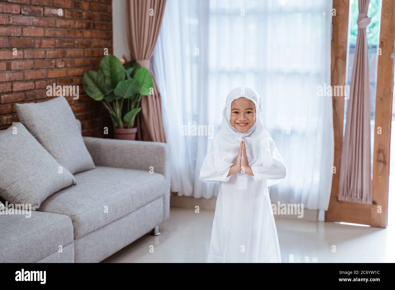 beautiful muslim toddler smiling with greeting gesture Stock Photo - Alamy
