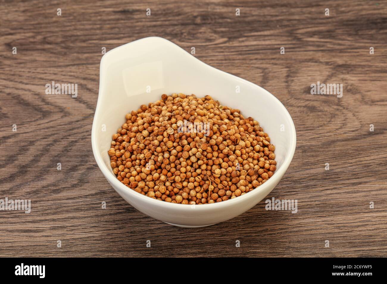 Dry Coriander seeds in the bowl Stock Photo - Alamy