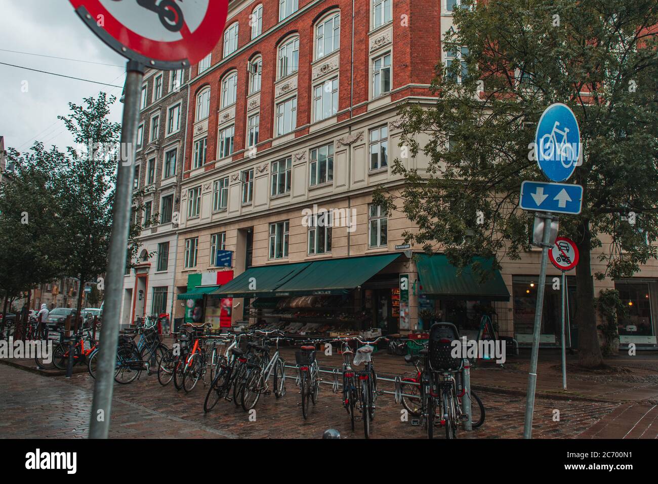 Selective focus of of bicycles and road signs on urban street in ...