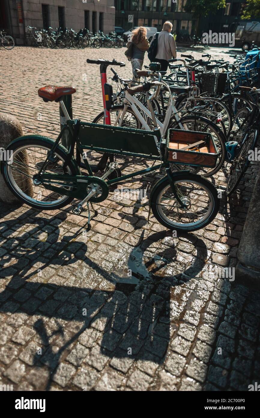 Bicycles on paving stone walkway on urban street of Copenhagen, Denmark ...