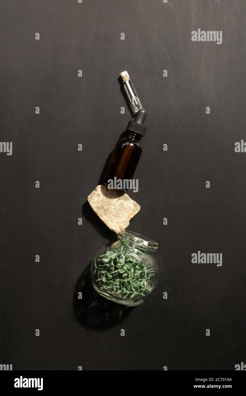 top view of balancing bottle with natural oil and natural materials on ...