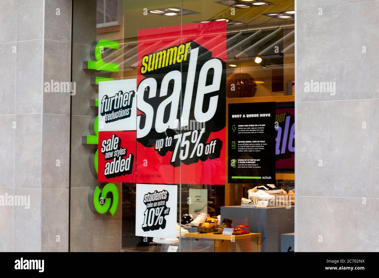 Shop window display advertising summer sale posters with up to seventy ...
