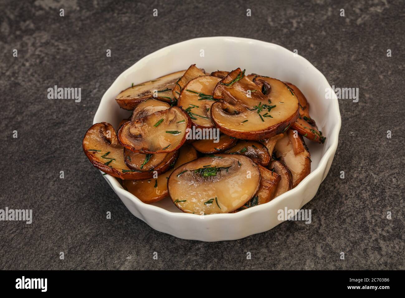 Roasted champignon with herbs and spices in the bowl Stock Photo - Alamy