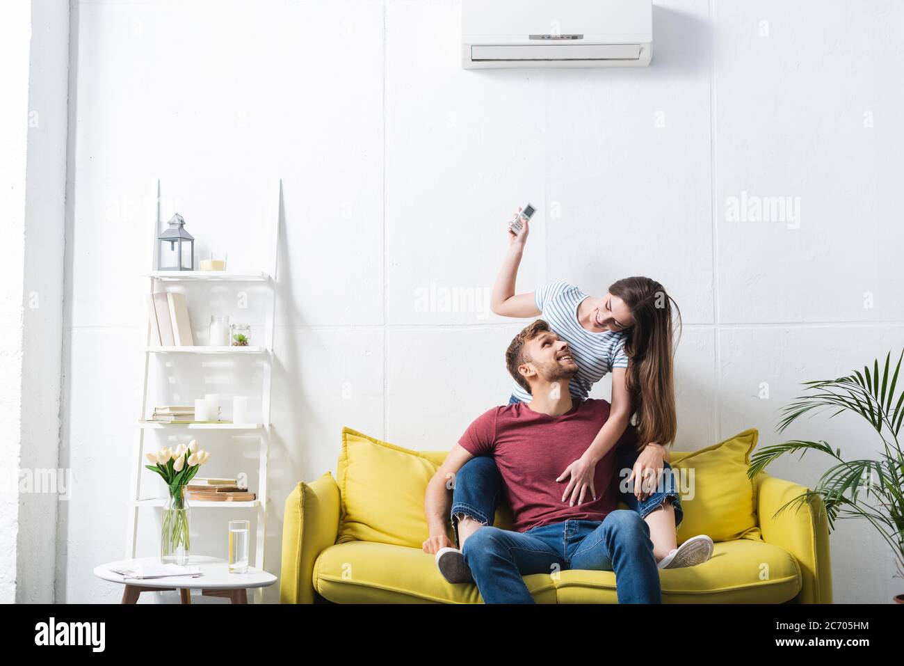 happy emotional couple hugging at home with air conditioner Stock Photo ...