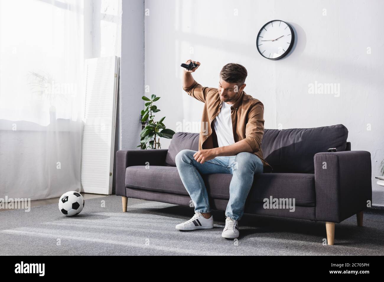 KYIV, UKRAINE - JUNE 9, 2020: angry man throwing joystick while losing ...