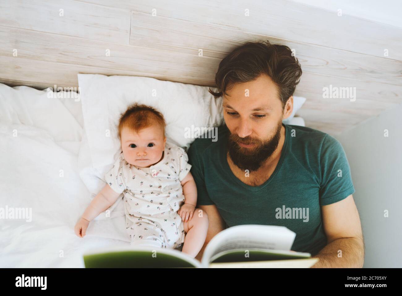 Father and baby daughter reading book fairytale at home lifestyle dad ...