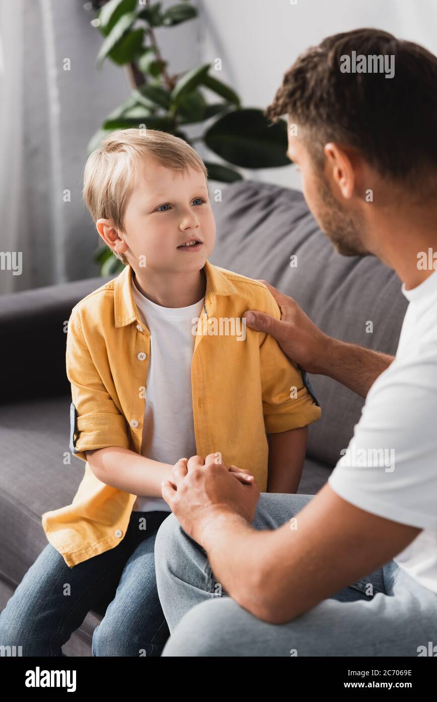 Child hand shoulder serious hi-res stock photography and images - Alamy