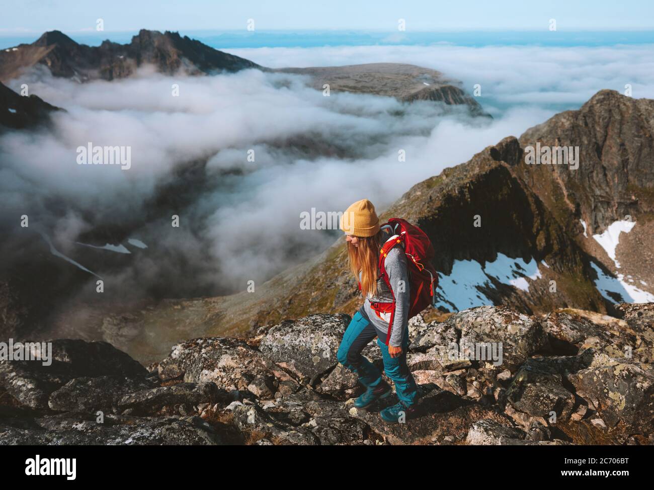 Woman adventurer hiking in mountains with backpack travel outdoor ...