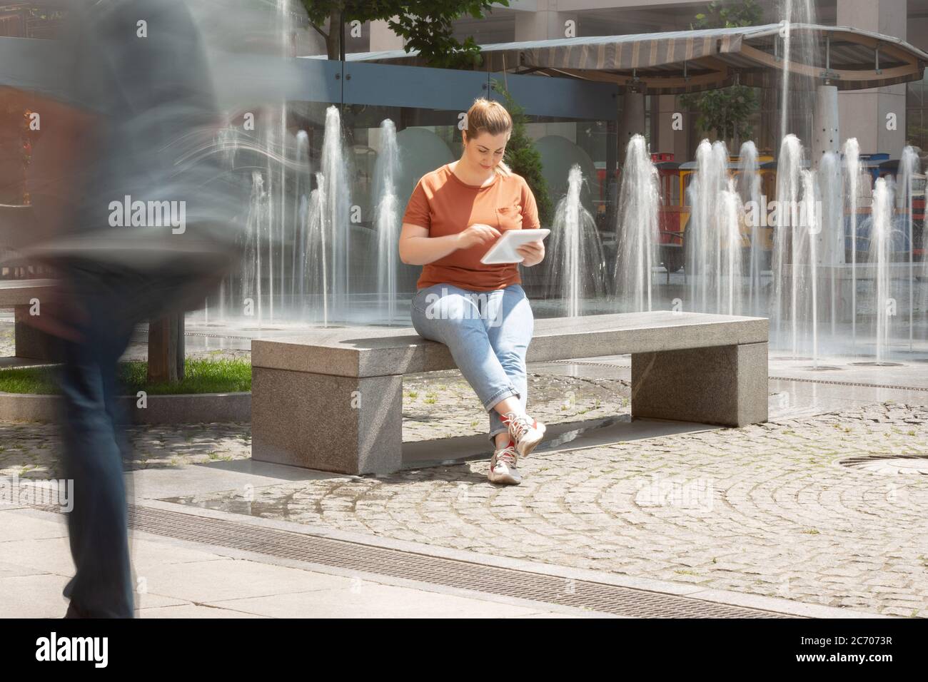 Using tablet. Caucasian inclusive plus-size model in daily routine ...