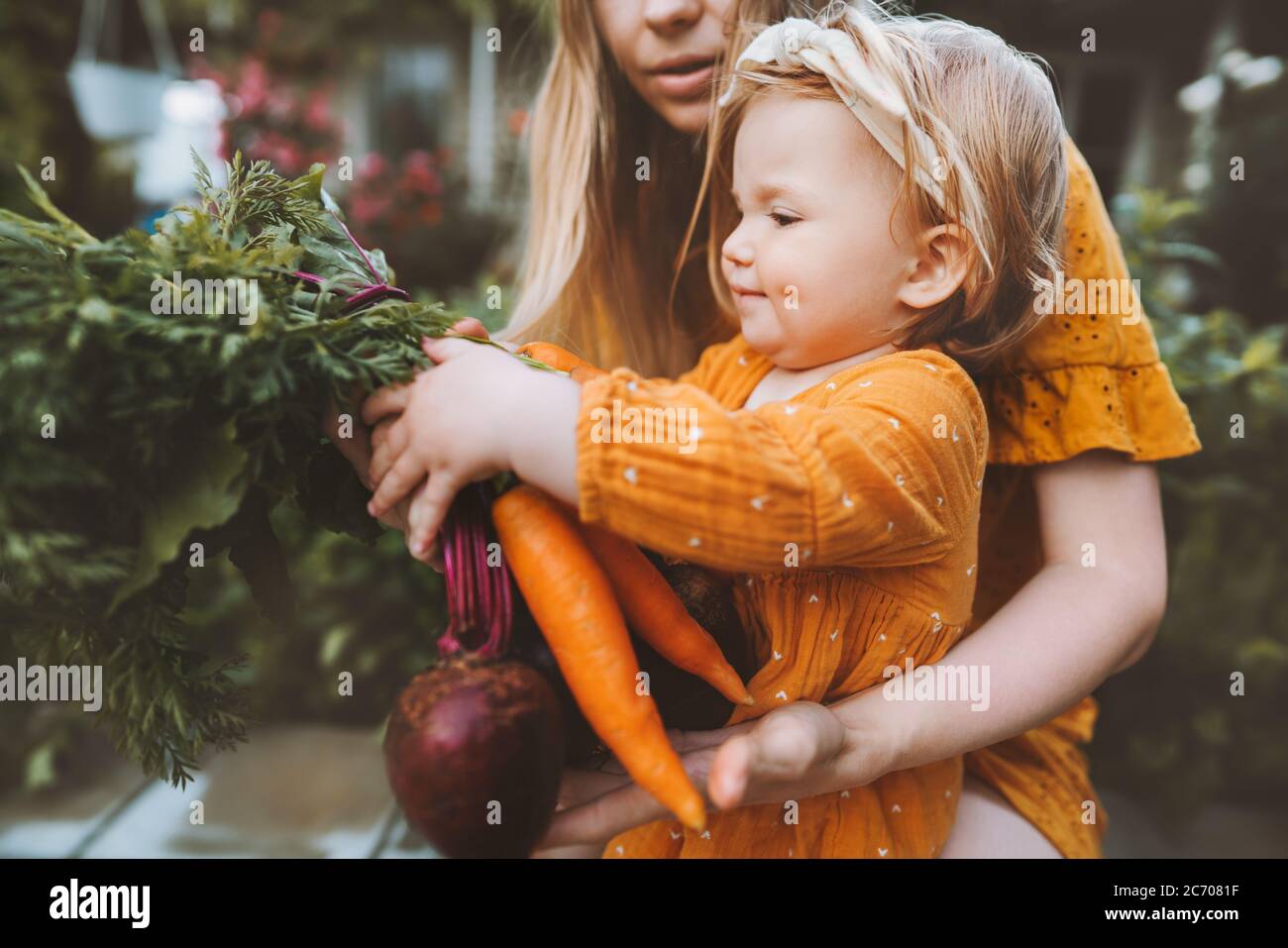 Family mother and child girl with organic vegetables healthy eating ...