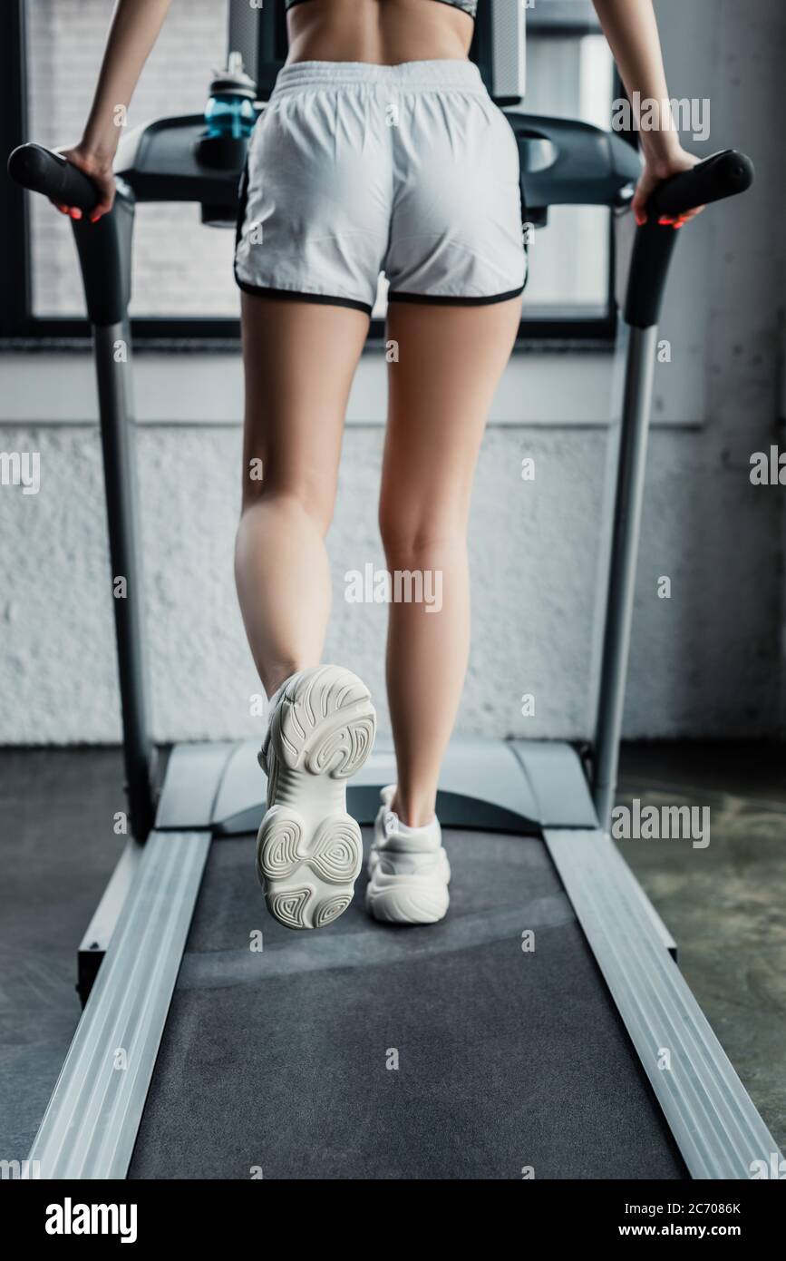 back view of sportswoman running on treadmill in gym Stock Photo - Alamy
