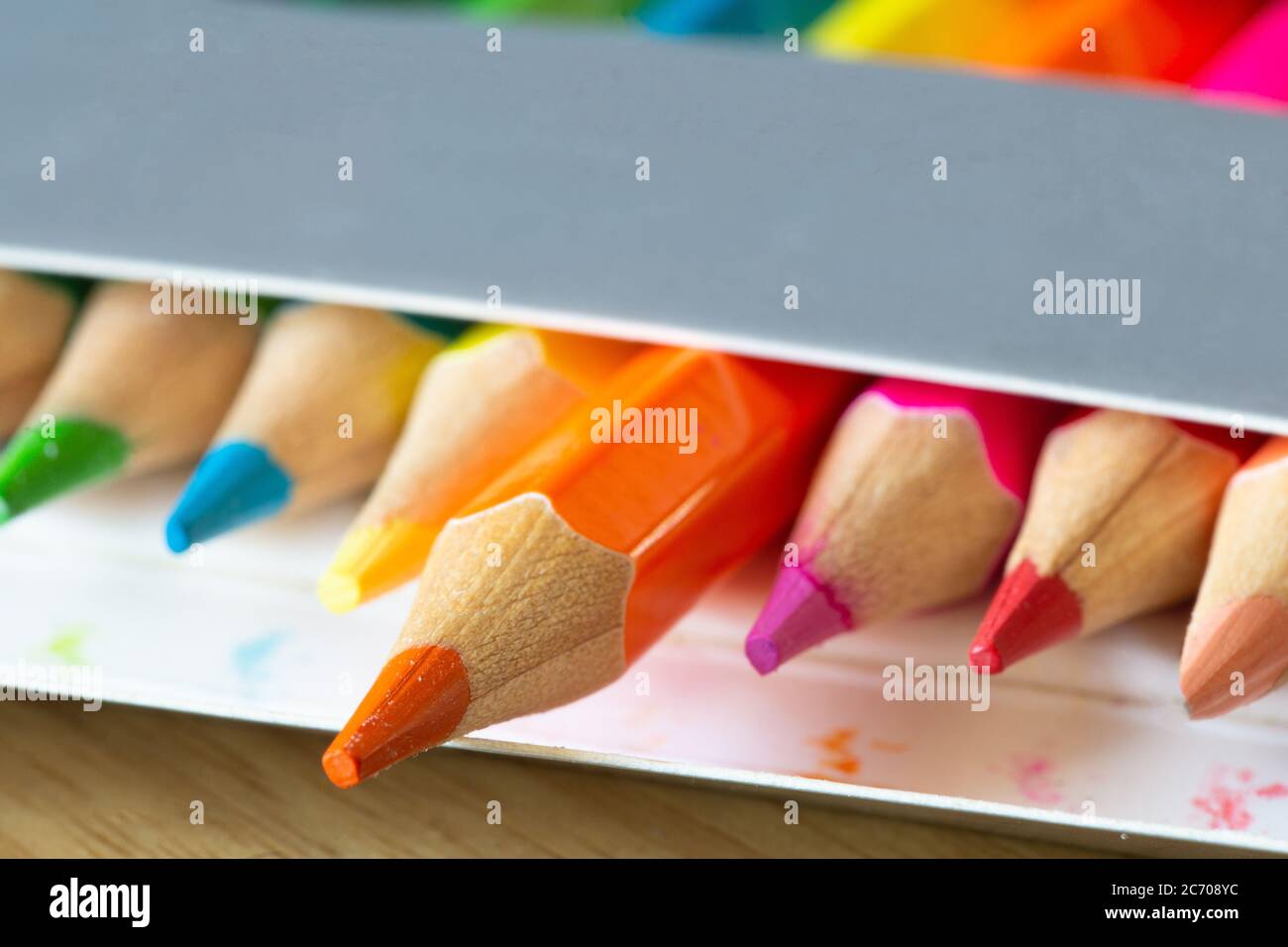 Colored pencils in a carton grey box, rainbow colors, orange pencil ...
