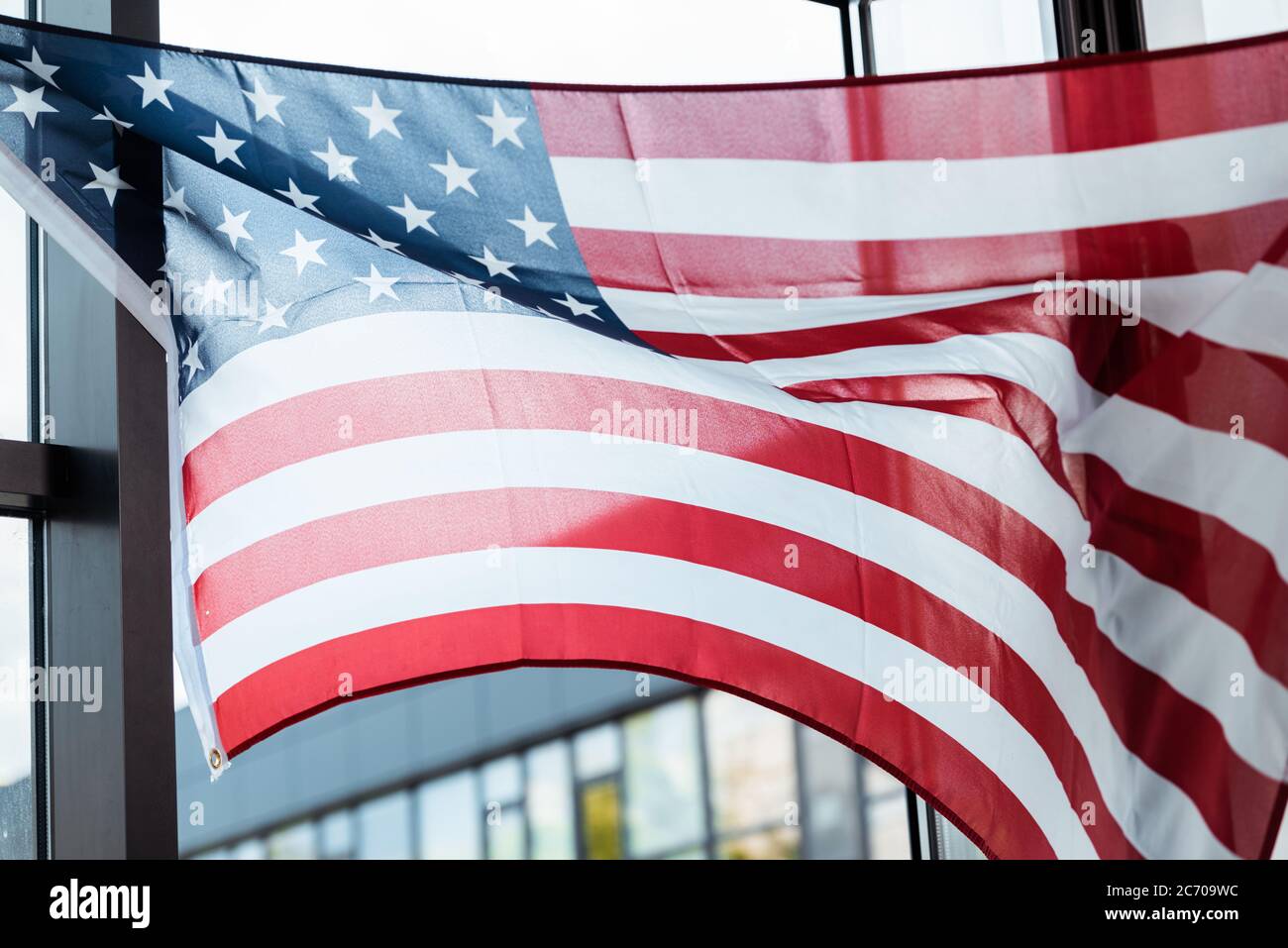 American flag near window in living room Stock Photo - Alamy