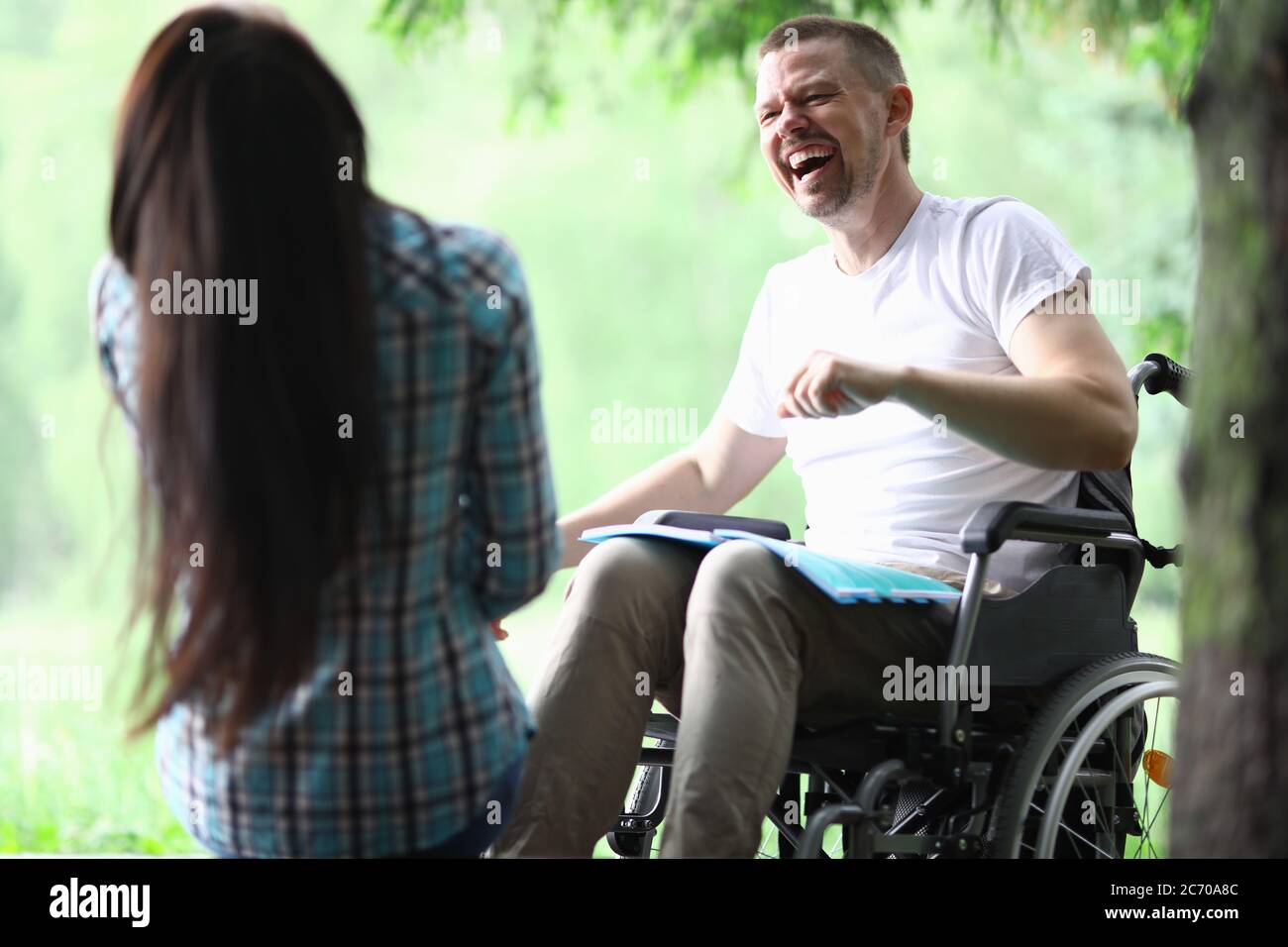 Male disabled man with girlfriend smiling on park walk portrait Stock ...