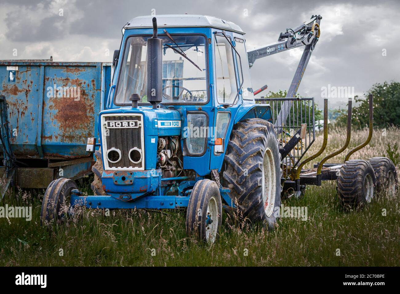 Ford 6600 tractor utility model with Riko trailer and crane Stock Photo ...