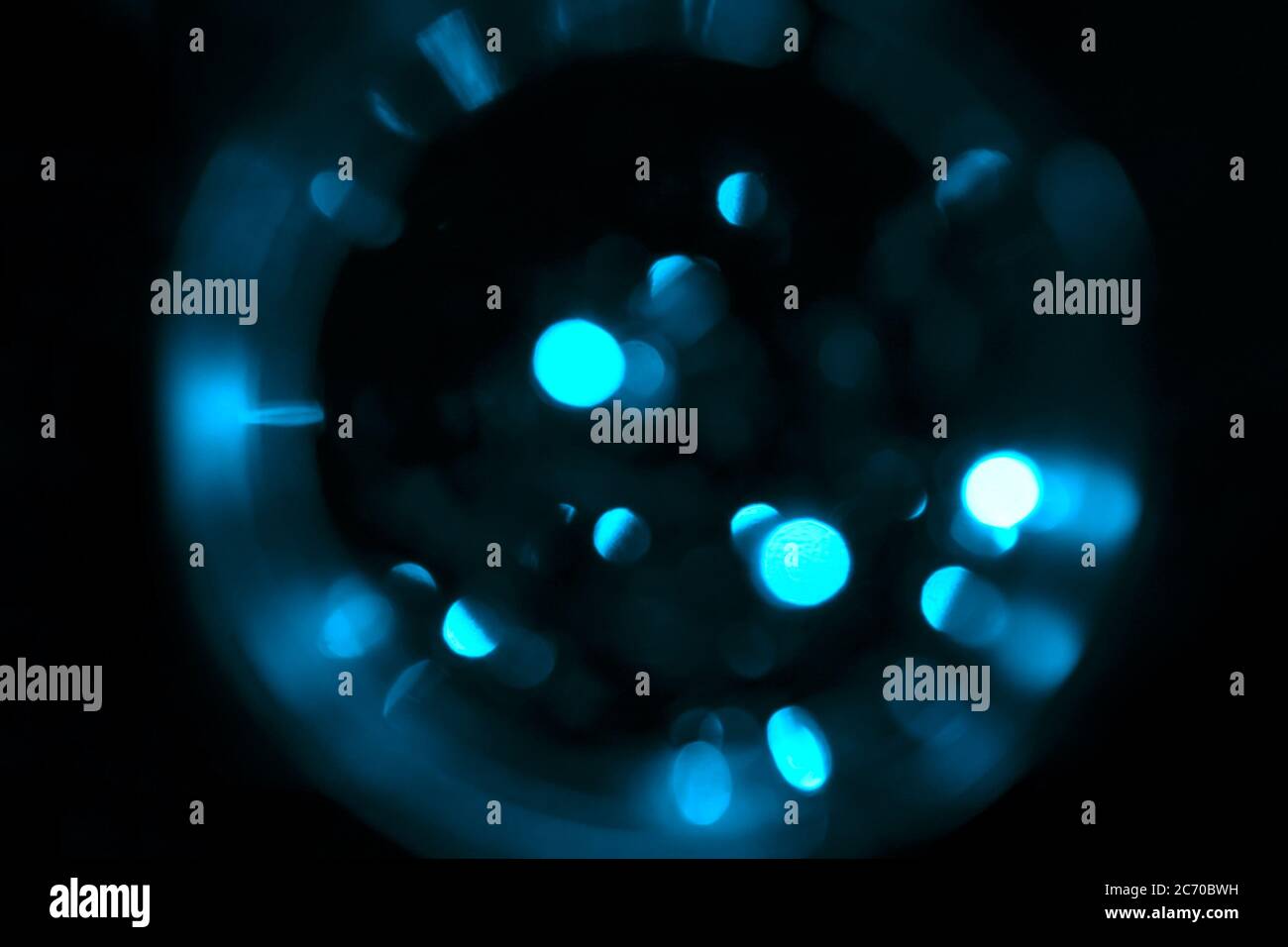 A sphere of blurred blue lights on a black background. Desktop ...