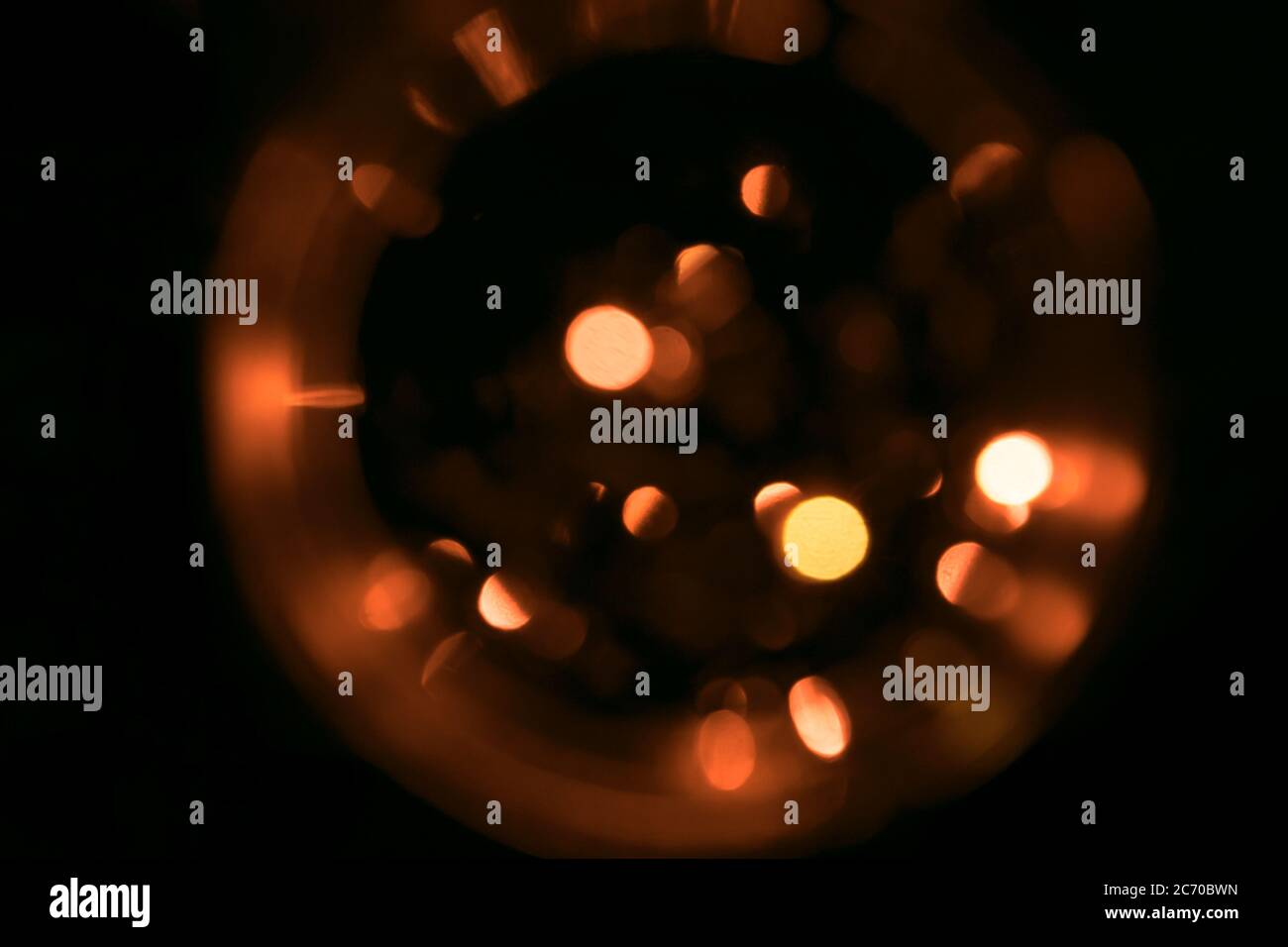 A sphere of blurred brown lights on a black background. Desktop ...