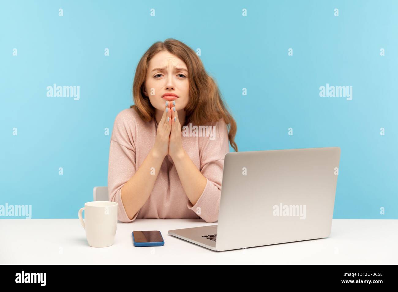 Please, need your help! Young woman employee sitting at workplace and ...