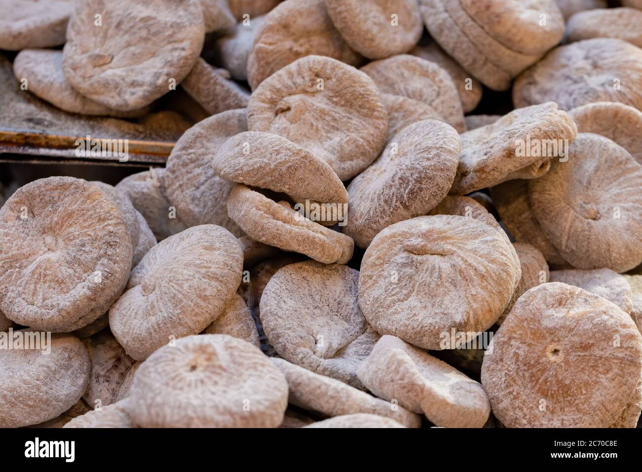 Pile of dried figs, coated in wheat flour, on a market stall in Borough ...
