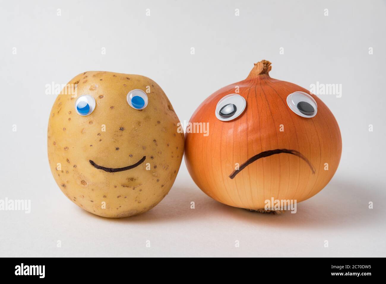 Positive potato and a sad Napiform onion with Googly eyes on a white ...