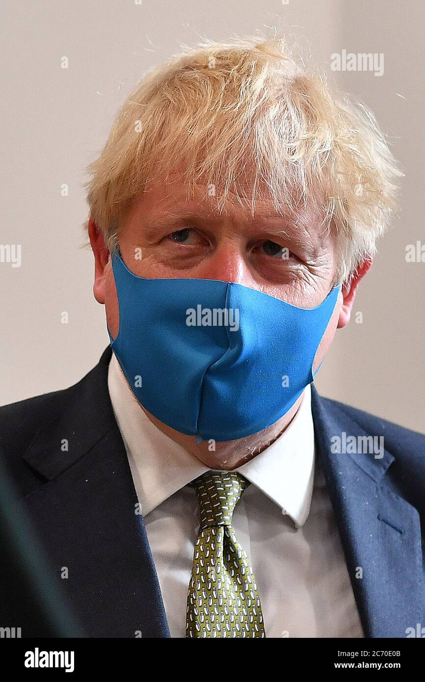 Prime Minister Boris Johnson, wearing a face mask, during a visit to ...