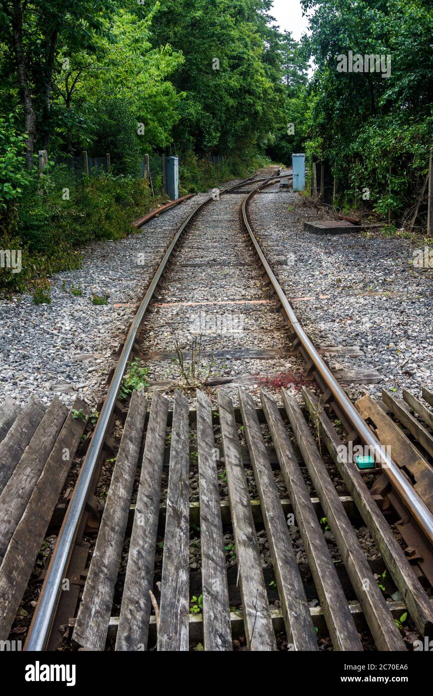 A single line railway track curves off into the distance Stock Photo ...