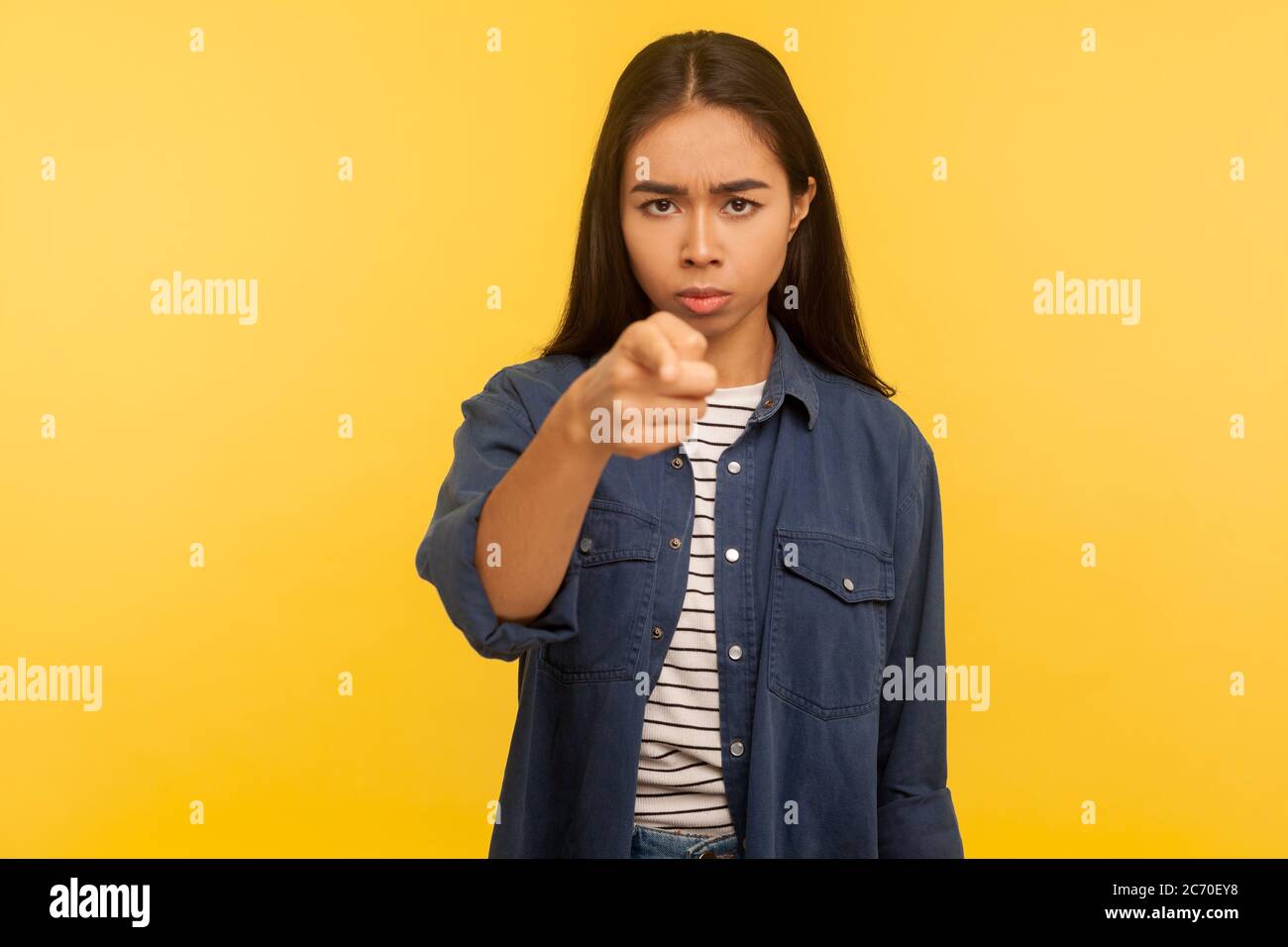 Hey you! Portrait of strict bossy angry girl in denim shirt pointing ...