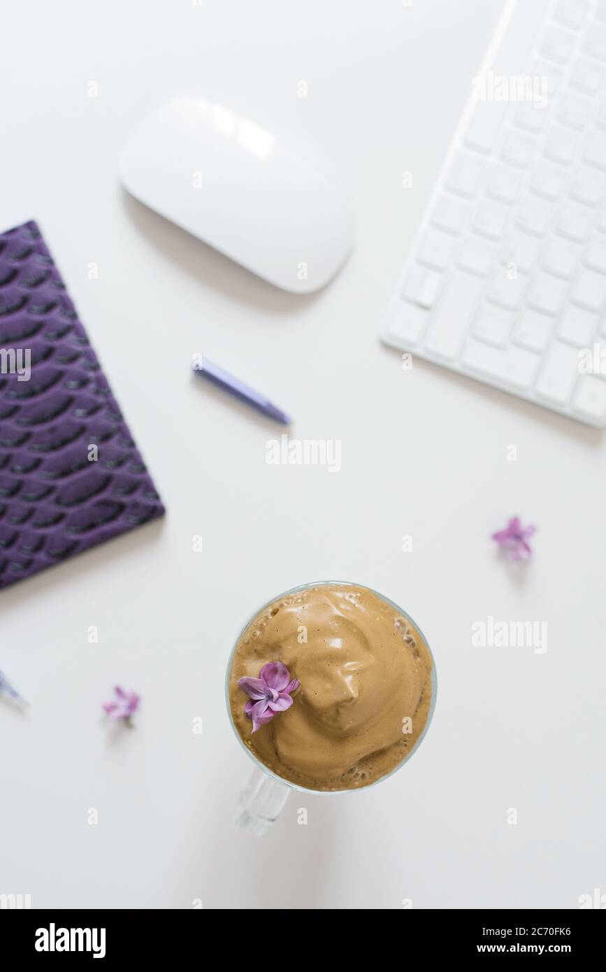 Coffee break at the workplace. Dalgona coffee, Notepad, pen and ...