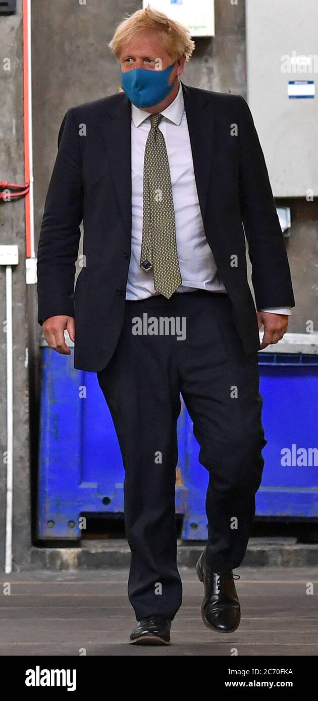 Prime Minister Boris Johnson, wearing a face mask, during a visit to ...