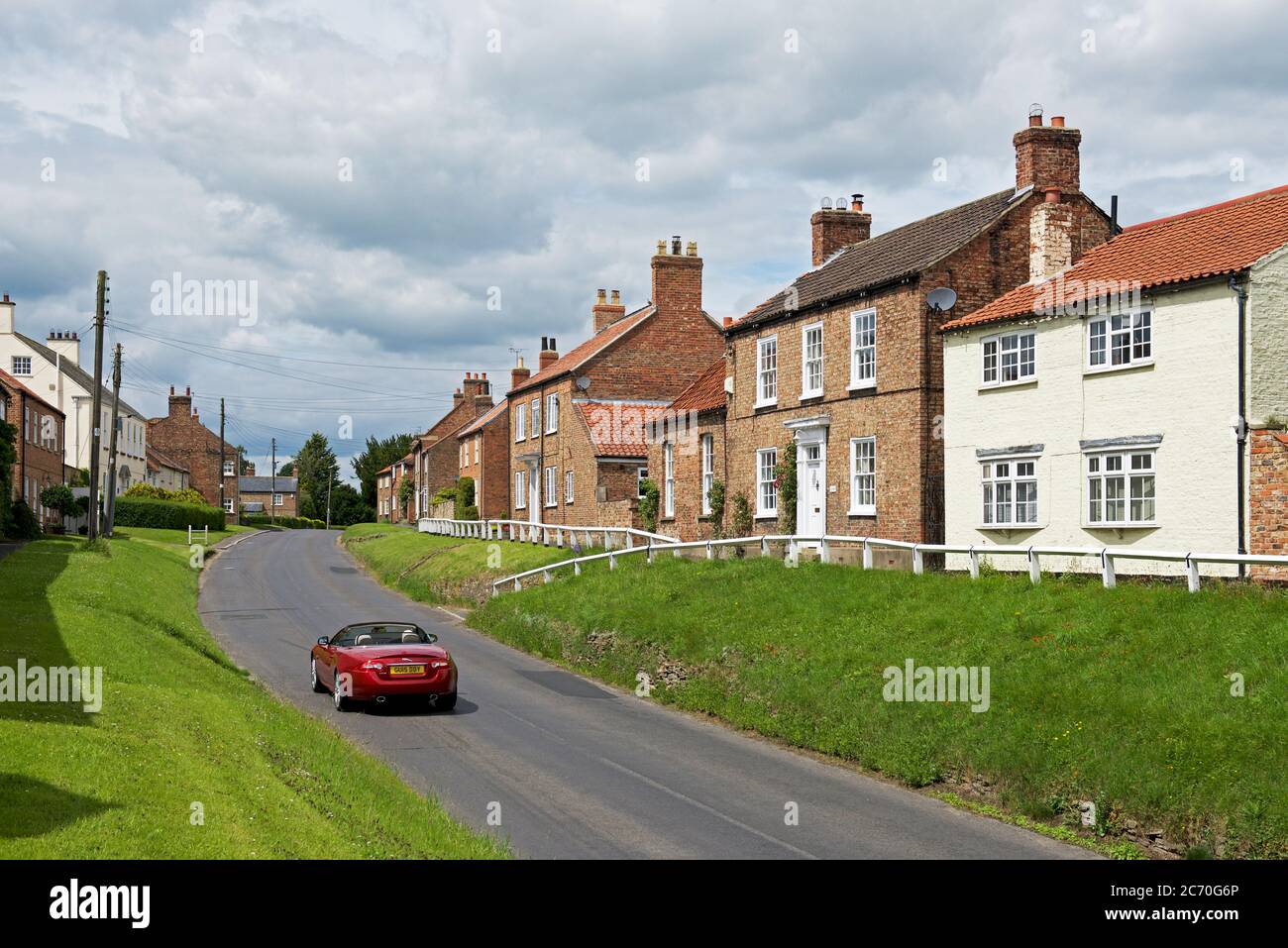 Red Jaguar XK sports car in the village of Stillington, North Yorkshire ...