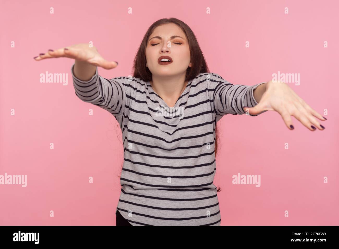 Portrait of blind disoriented woman in striped sweatshirt walking with ...