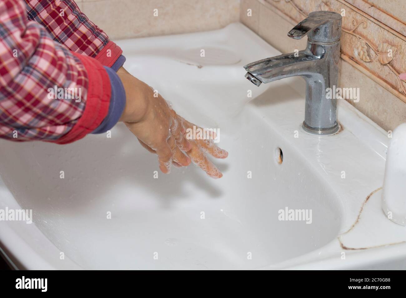 washing hands under faucet Stock Photo - Alamy