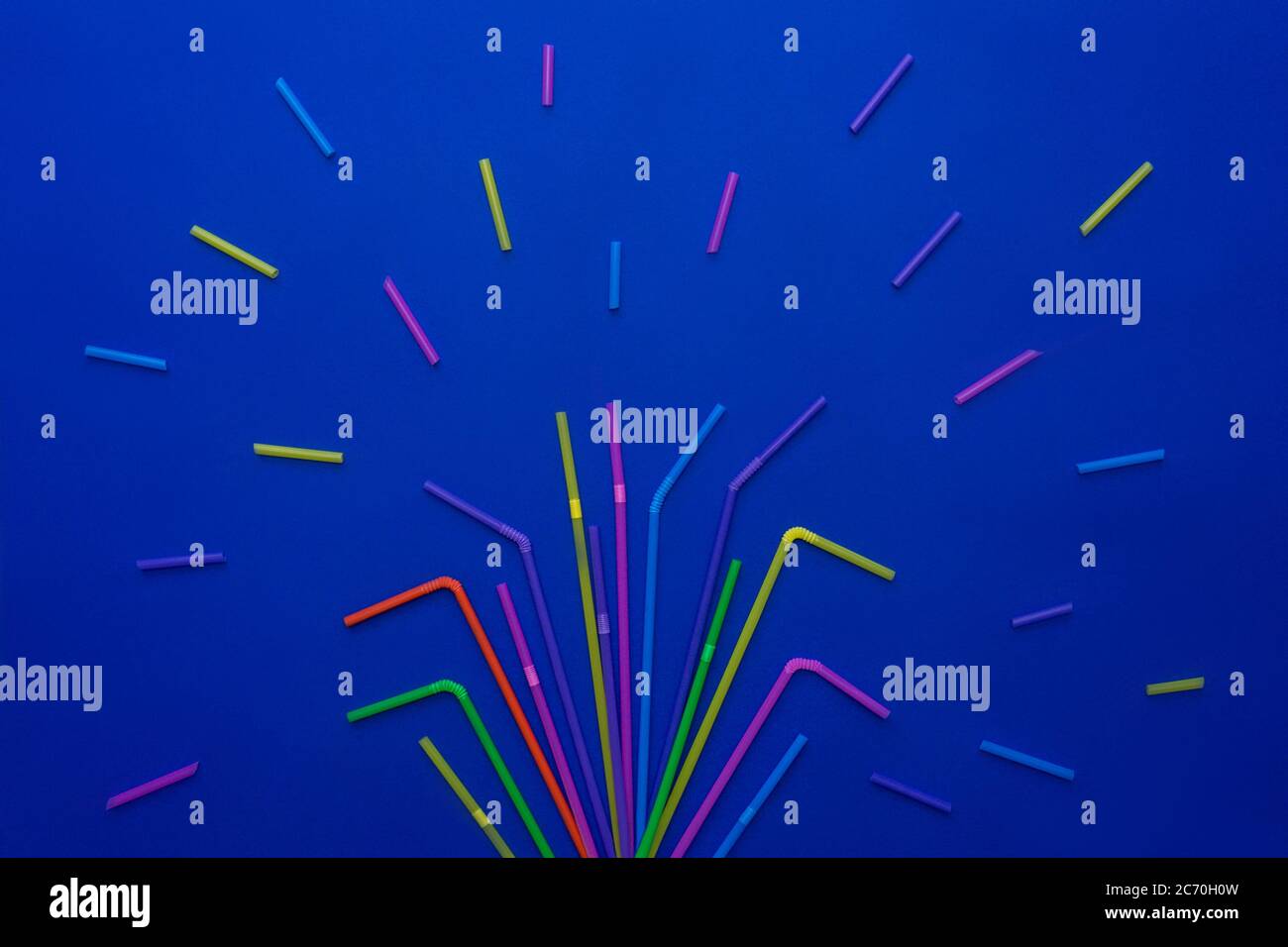 Multi-colored straws for drinking cocktail on blue background, holiday ...