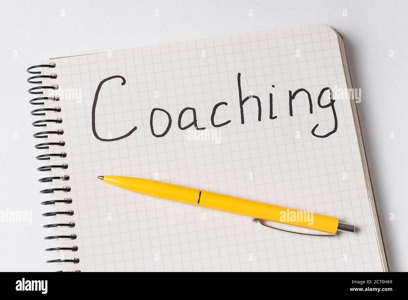 Word COACHING in notepad. Handwritten. White background Stock Photo - Alamy