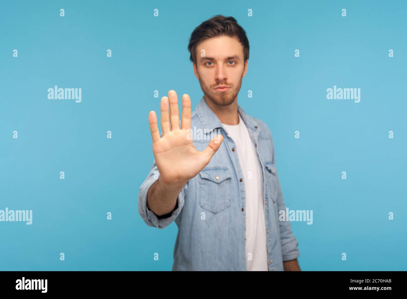 Prohibition, denied access. Portrait of serious man in worker denim ...