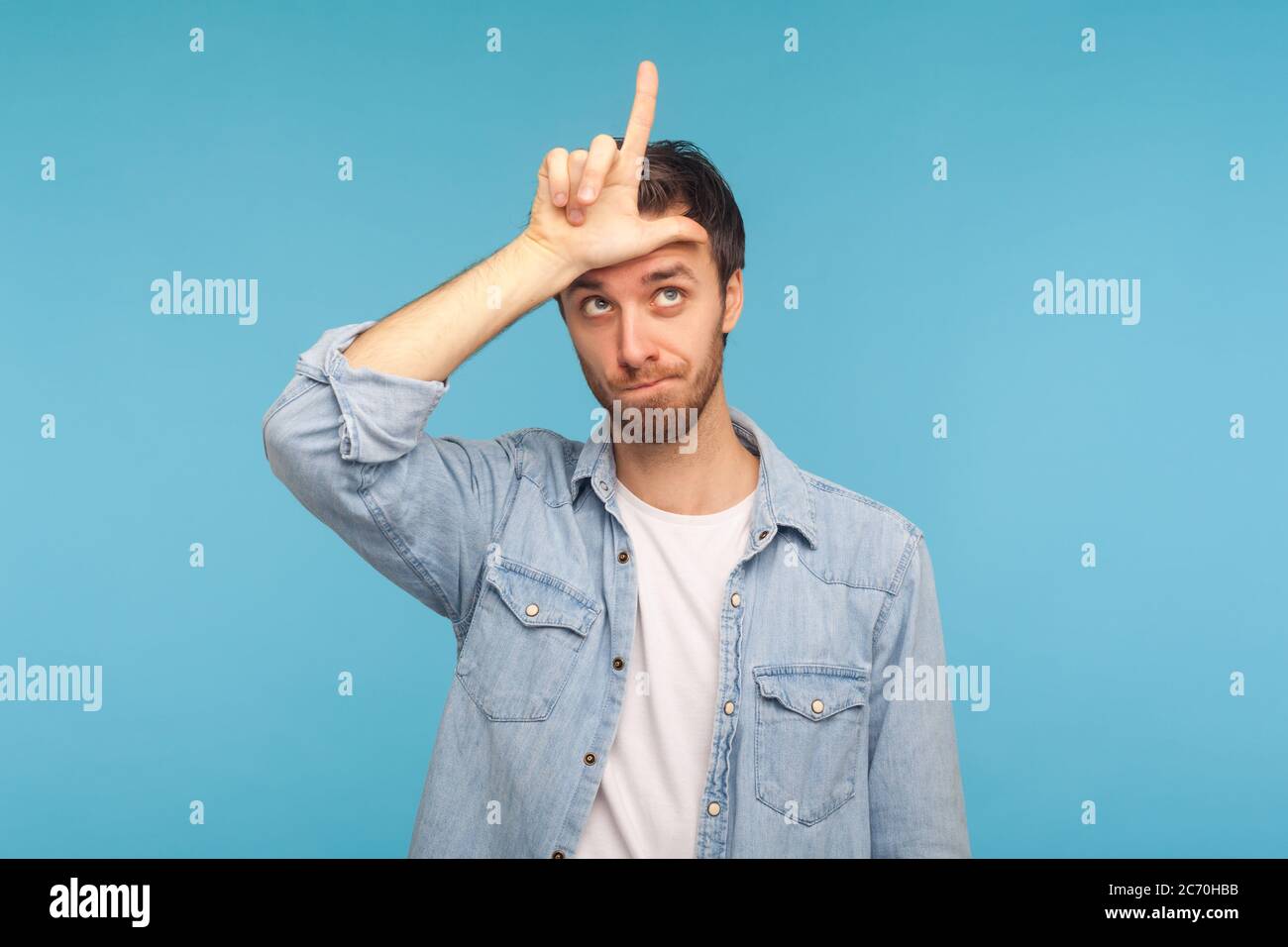 I lost job! Portrait of depressed man in worker denim shirt showing ...