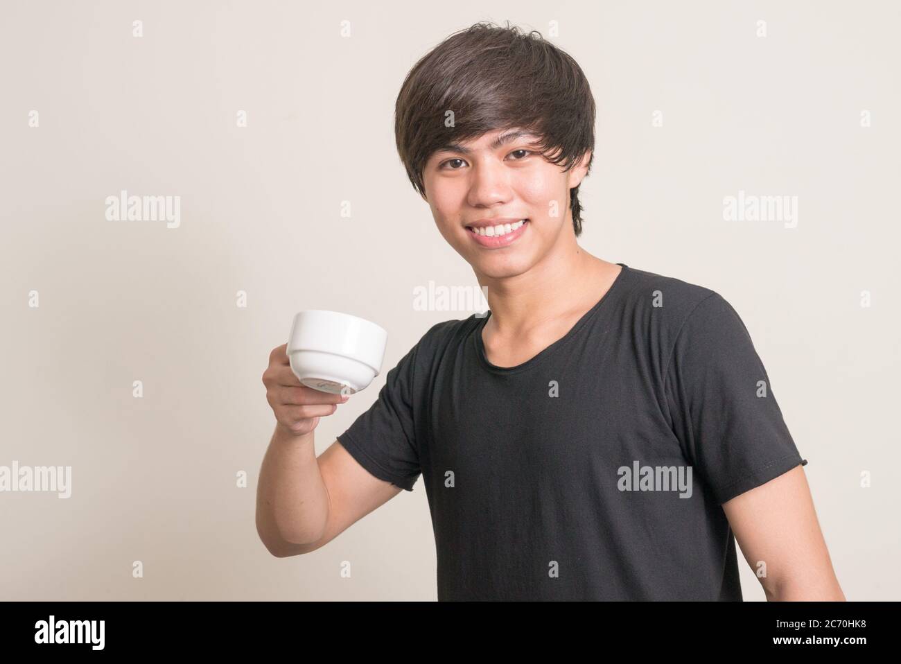 Portrait of happy young Filipino man drinking coffee Stock Photo - Alamy