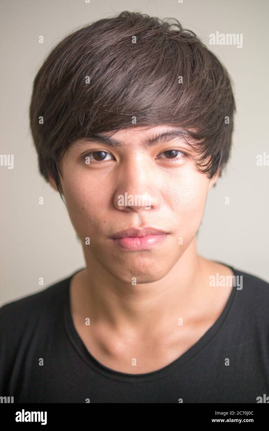 Face of young Filipino man looking at camera Stock Photo - Alamy