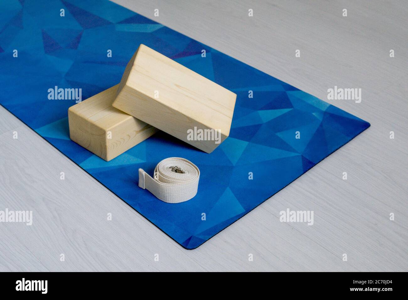 Flat lay from yoga equipment. Blue mat, blocks, yoga blanket and belt ...