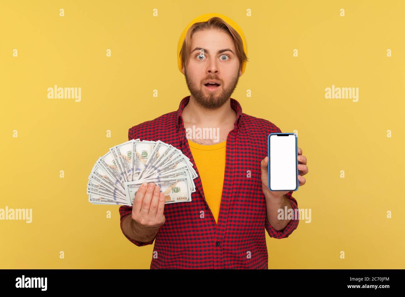 Mobile money transfer, online banking. Surprised hipster guy in ...
