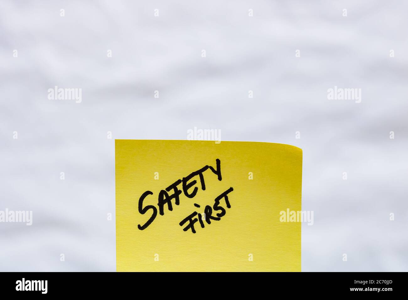 Safety first handwriting text close up isolated on yellow paper with ...