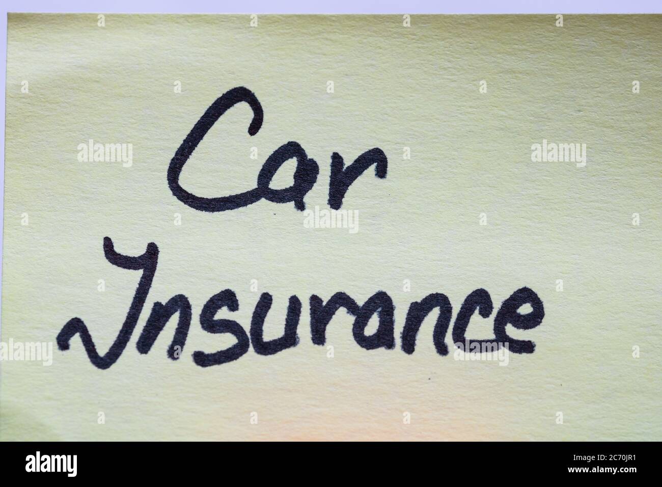 Car insurance handwriting text close up isolated on yellow paper with ...