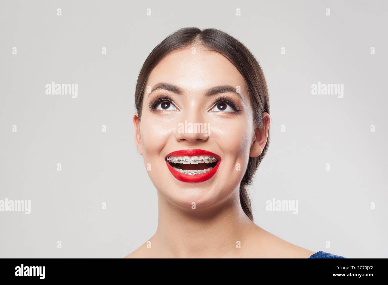 Exsited woman with braces on teeth, close up portrait Stock Photo - Alamy