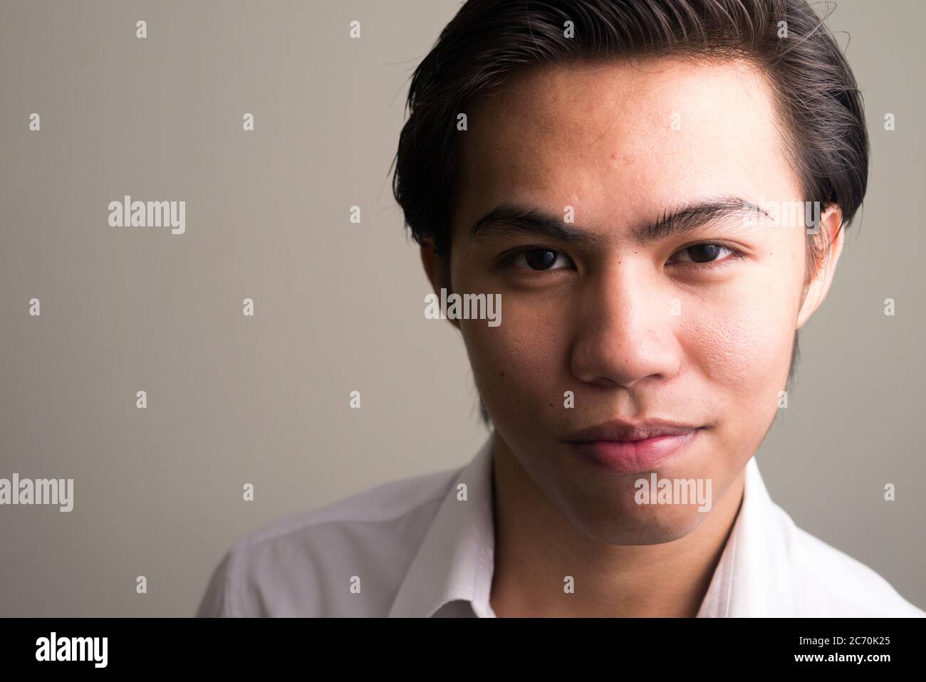 Face of young Filipino businessman looking at camera Stock Photo - Alamy